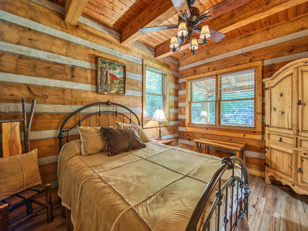 The Log Cabin At Night With The Jacuzzi Lite And Fire Blazing